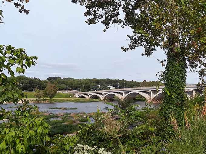 The Dan River bridge stretches gracefully across the water, proving that infrastructure can be both functional and beautiful.