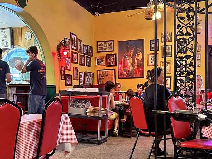 Red-checkered tablecloths and golden walls create warmth that makes strangers feel like family within minutes.