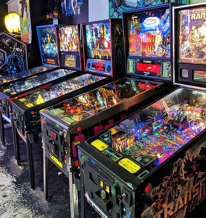 Pinball machines lined up like chrome soldiers, each one ready to break your heart and steal your quarters gloriously.