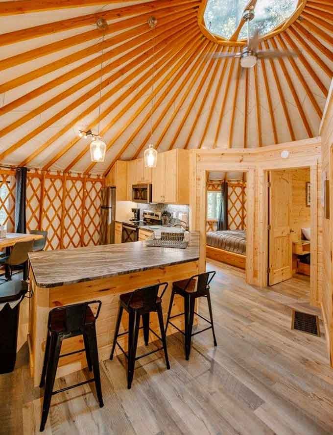 The ceiling alone is worth the trip, radiating wooden beams like a sunburst over your fully equipped kitchen.