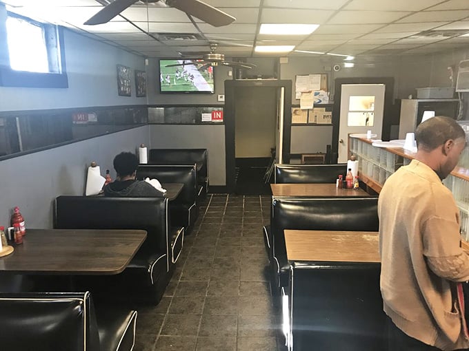 Simple booths, drop ceiling tiles, and a TV playing in the corner: this is where real food happens, folks.