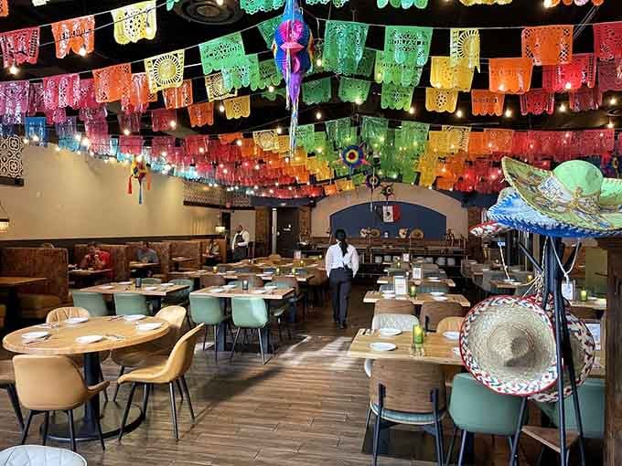 Those papel picado banners overhead create a canopy of celebration that makes every meal feel special.