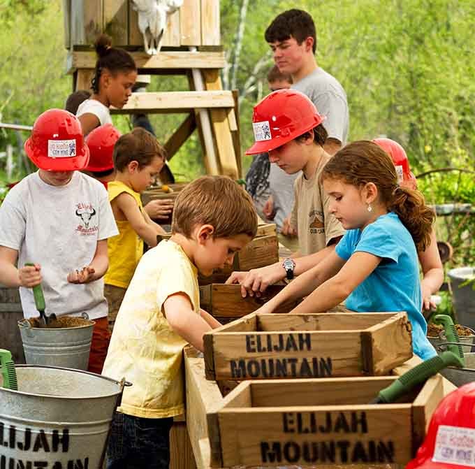 Kids in mining helmets taking their job seriously, because finding amethyst is serious business, people.