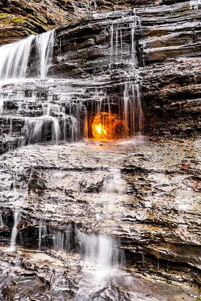 Those layered shale walls hold millions of years of secrets, while water and flame perform their eternal dance.
