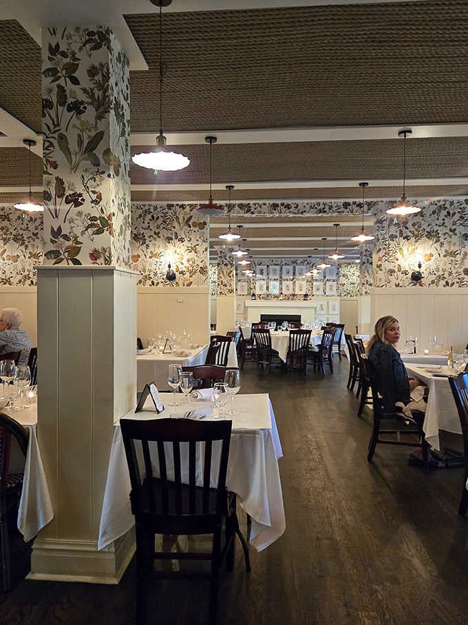 White tablecloths and floral accents create an atmosphere that whispers "special occasion" without shouting "stuffy."