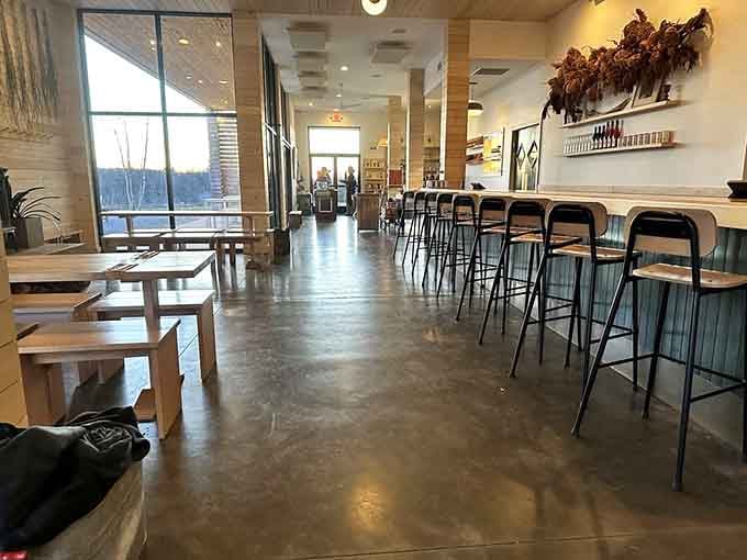 Clean lines and natural light define Farm Club's interior, where polished concrete meets wooden warmth in perfect harmony.