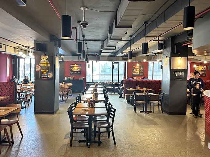 Industrial-chic meets comfortable dining where exposed pipes and warm lighting create the perfect interactive eating atmosphere.