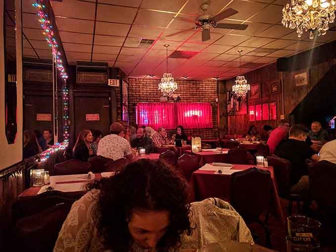 Crystal chandeliers and red leather booths create an atmosphere where every meal feels like opening night.