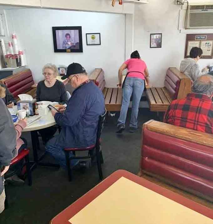 Red vinyl booths and framed memories create the kind of atmosphere where strangers become friends over coffee.