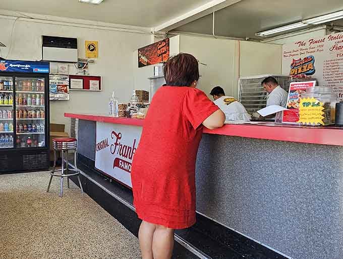 The no-frills counter setup tells you everything: this place focuses on what matters most, the pizza itself.
