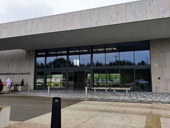 Modern architecture meets natural beauty at an entrance that promises something extraordinary awaits inside.