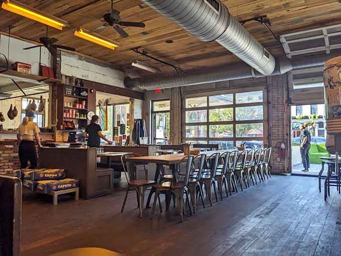 Industrial chic meets neighborhood hangout, where exposed ductwork and communal tables create the perfect pizza-eating atmosphere.