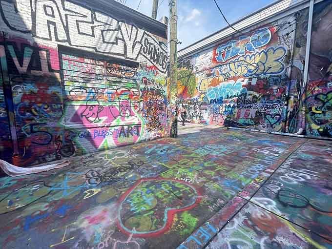 The ground itself tells stories here, layered with years of artistic expression in every vibrant splash of color.