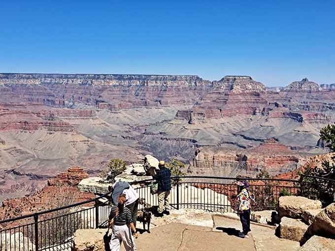 Visitors gather at the overlook, united in their collective jaw-dropping moment of pure natural wonder and amazement.