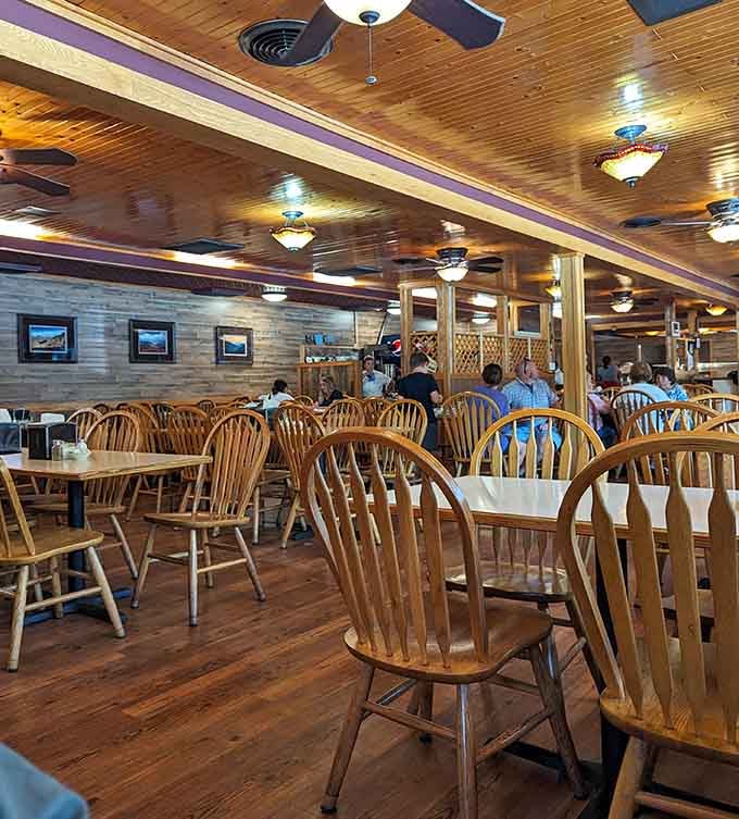 Wood-paneled walls and ceiling fans create the kind of comfortable dining room where nobody's rushing you out.