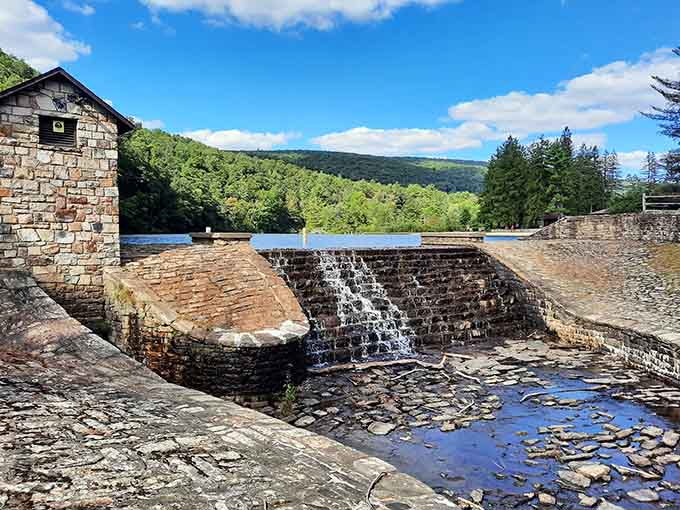 The historic stone spillway proves that even 19th-century engineering can be Instagram-worthy when nature takes over.