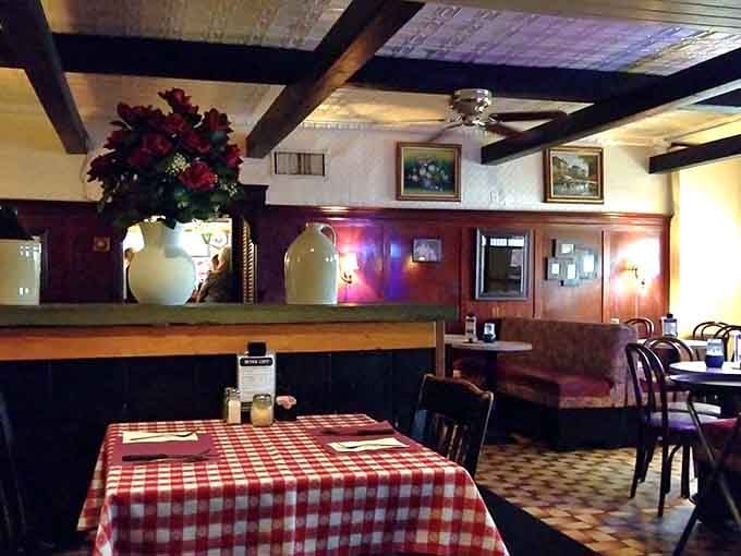 Red checkered tablecloths and exposed beams create the kind of timeless atmosphere where good conversations happen naturally.