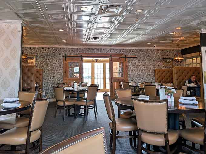 Step inside where decorative ceiling tiles meet comfortable booths, proving elegance doesn't require stuffiness or pretension.