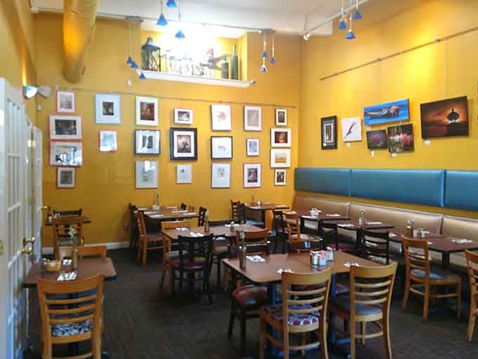 Sunny yellow walls and local artwork create the kind of welcoming atmosphere that makes strangers feel like regulars.