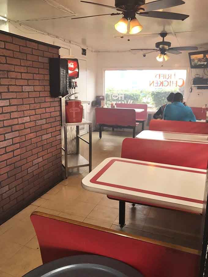 Classic red booths and ceiling fans create the perfect no-frills atmosphere where chicken takes center stage, not Instagram.