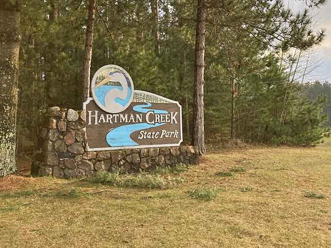That rustic stone-and-wood entrance sign isn't just welcoming you, it's promising an escape from reality.