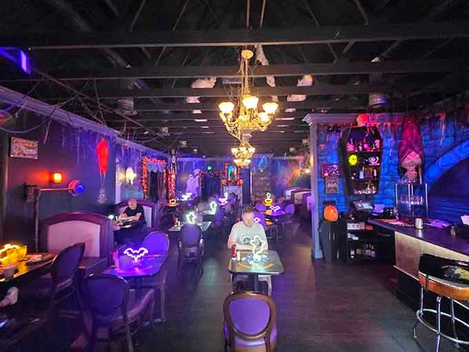 Purple lighting and mismatched furniture create an atmosphere where Tim Burton would feel completely at home ordering lunch.