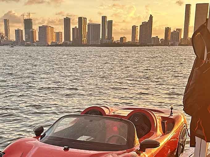 Golden hour meets automotive impossibility, proving Miami sunsets make even floating sports cars look like fine art.