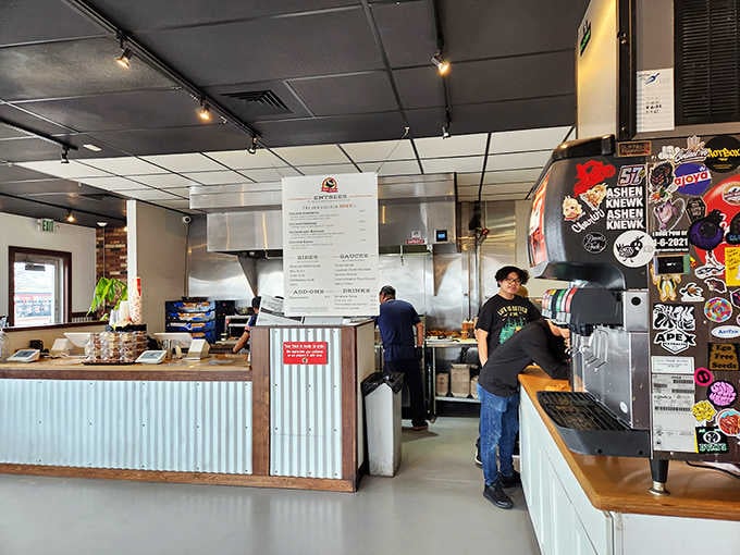 The open kitchen and corrugated metal counter create an honest, welcoming space where great food takes center stage.