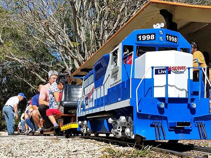 That brilliant blue diesel engine looks ready to haul freight, except its cargo is pure happiness and delighted passengers.