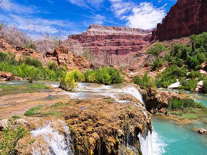 The layered canyon walls frame this aquatic masterpiece like it's hanging in the world's most exclusive gallery.