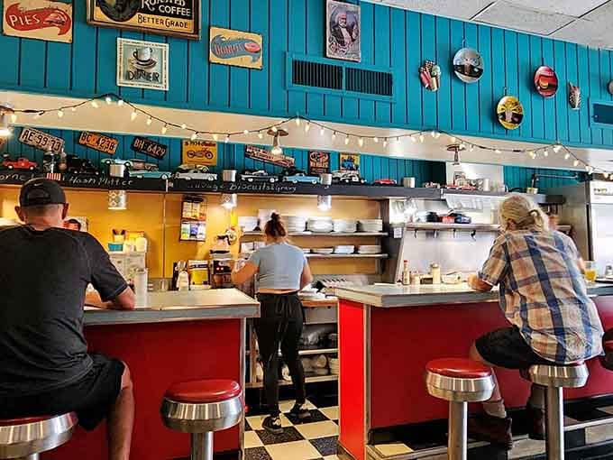 Chrome stools and turquoise walls create the perfect backdrop for serious comfort food consumption.