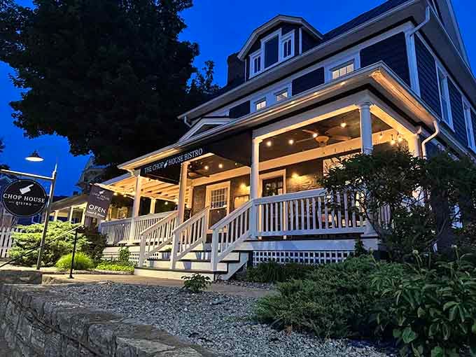 Evening lights and wraparound porches create the kind of welcoming scene that makes you slow down and breathe.