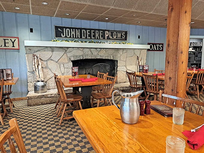 Wooden beams, stone fireplace, and John Deere signs create the coziest barn you've ever dined in.