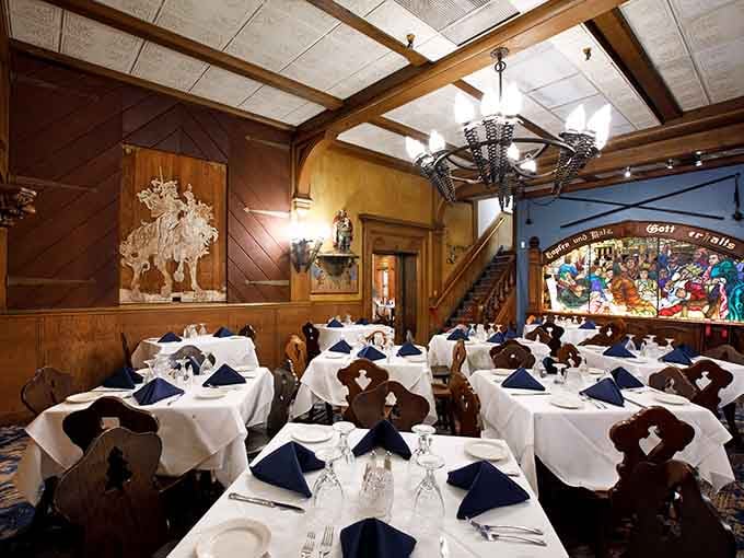 Dark wood, stained glass, and white tablecloths create an atmosphere where every meal feels like a celebration.