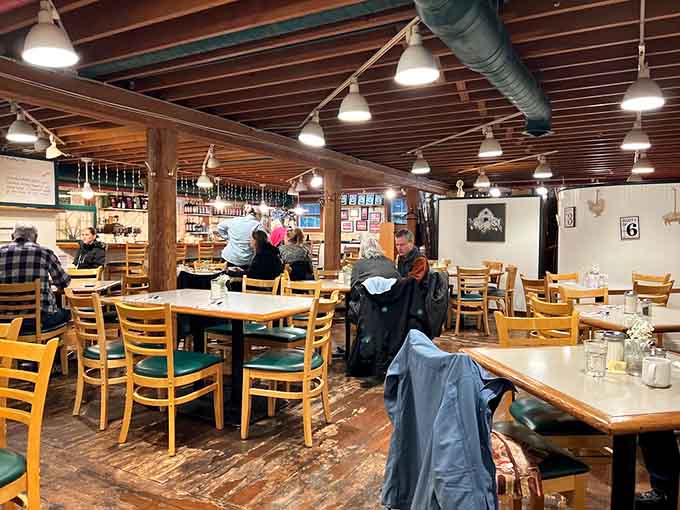 Exposed beams, wooden tables, and pendant lights create that cozy diner vibe where calories magically don't count.