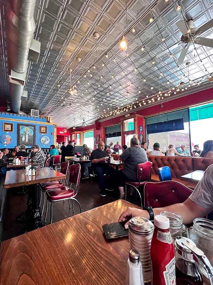 The tin ceiling sparkles overhead while happy diners dig into plates that could feed a small army, contentedly.