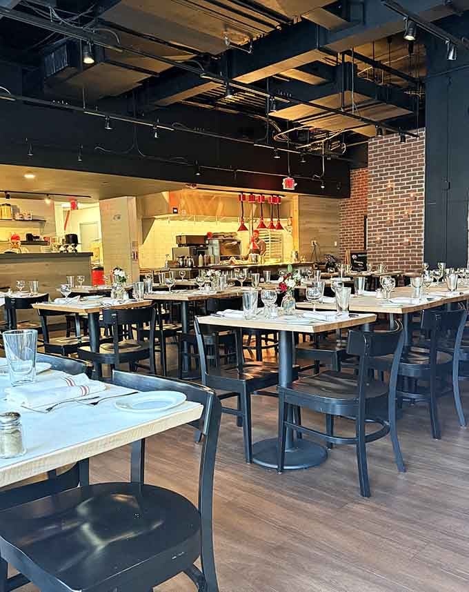 Industrial chic meets neighborhood warmth in this dining room where exposed brick and open kitchens create dinner theater.