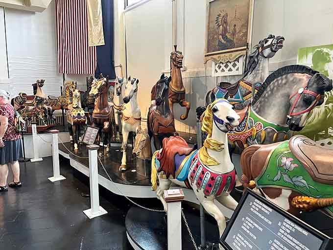 Hand-carved wooden steeds frozen mid-gallop, each one a masterpiece waiting to carry you back through time.