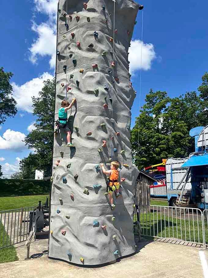 Kids scaling this climbing wall like tiny mountaineers conquering Everest, proving adventure doesn't need a passport or fancy equipment.