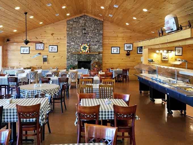 Wood paneling, checkered tablecloths, and a stone fireplace create the coziest dining room in Alabama.