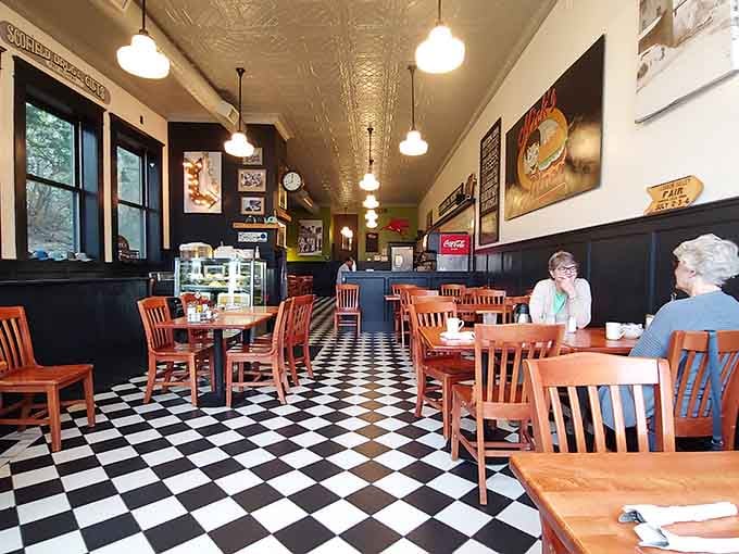 Black and white checkered floors and tin ceilings create the kind of timeless atmosphere that makes every meal feel special.