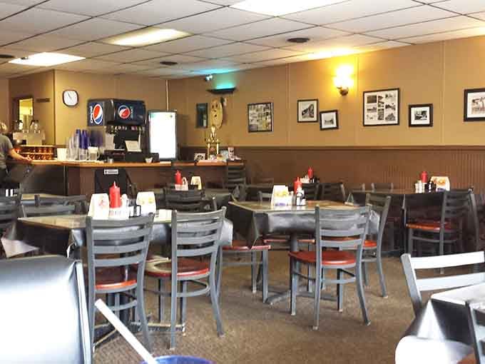 Clean tables, warm lighting, and framed local photos. This dining room means serious, unpretentious business.