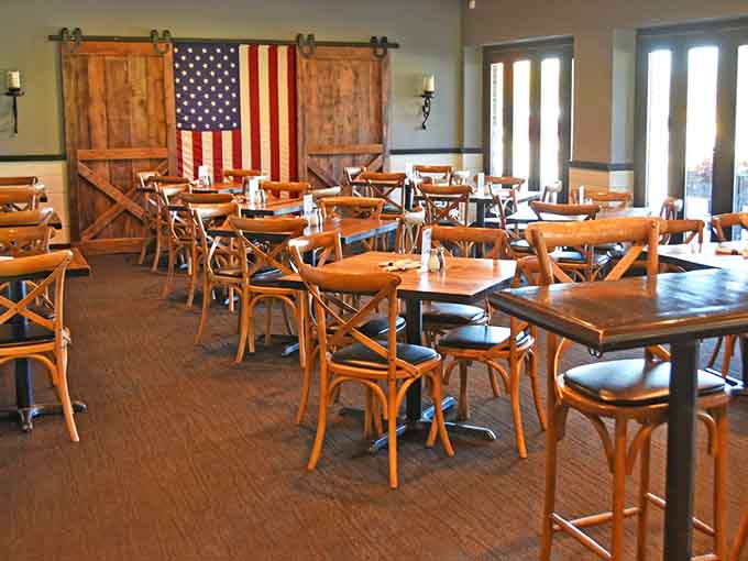 Barn doors and American flags create a rustic vibe that feels both patriotic and perfectly comfortable for any meal.