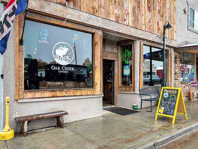 The Oak Creek Tavern's weathered wood exterior has absorbed more good stories than most people hear in a lifetime.