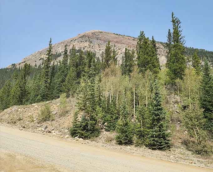 That dirt road winding through aspens? Your gateway to one of Colorado's most spectacular hidden treasures.
