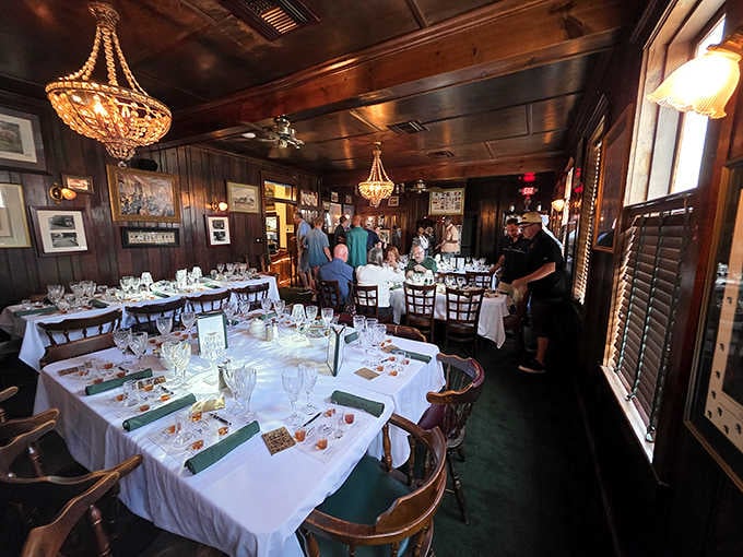 Dark wood, white linens, and chandeliers create the perfect setting where elegance meets genuine Louisville hospitality.