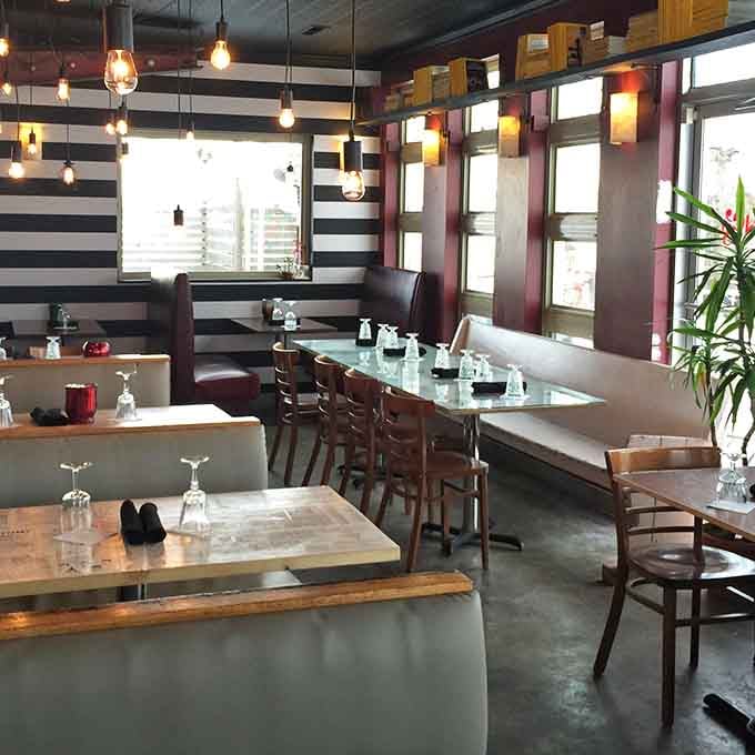 The modern yet cozy interior features striking black-and-white striped walls that create an inviting contemporary atmosphere.