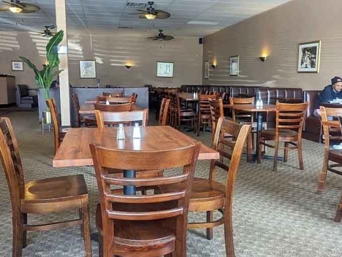 Spacious dining room where wooden chairs and tables await your arrival like old friends ready for reunion.