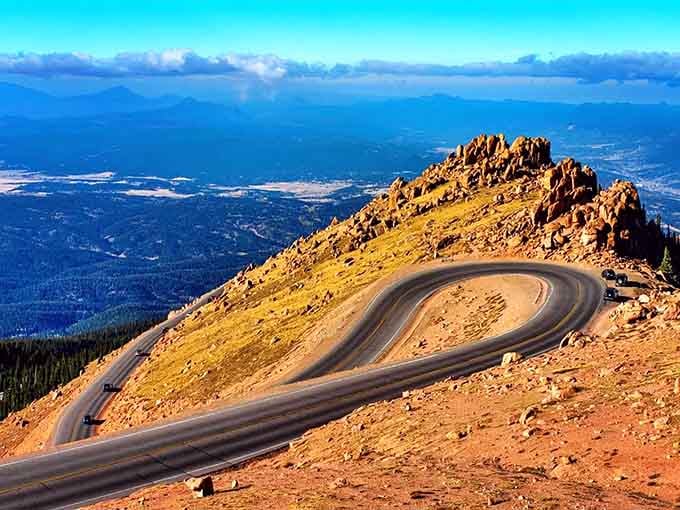 Pikes Peak Highway's smooth pavement snakes past ancient rock formations that have witnessed millennia of geological drama.