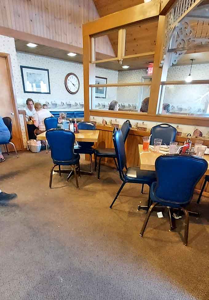 Warm wood tones, blue chairs, and a ticking clock: the holy trinity of a proper American diner.